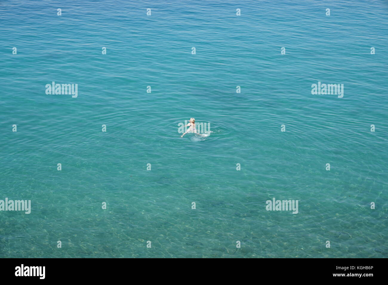 Corfu, Greece: Woman swimming in the sea at the beach of Kerkyra Old ...