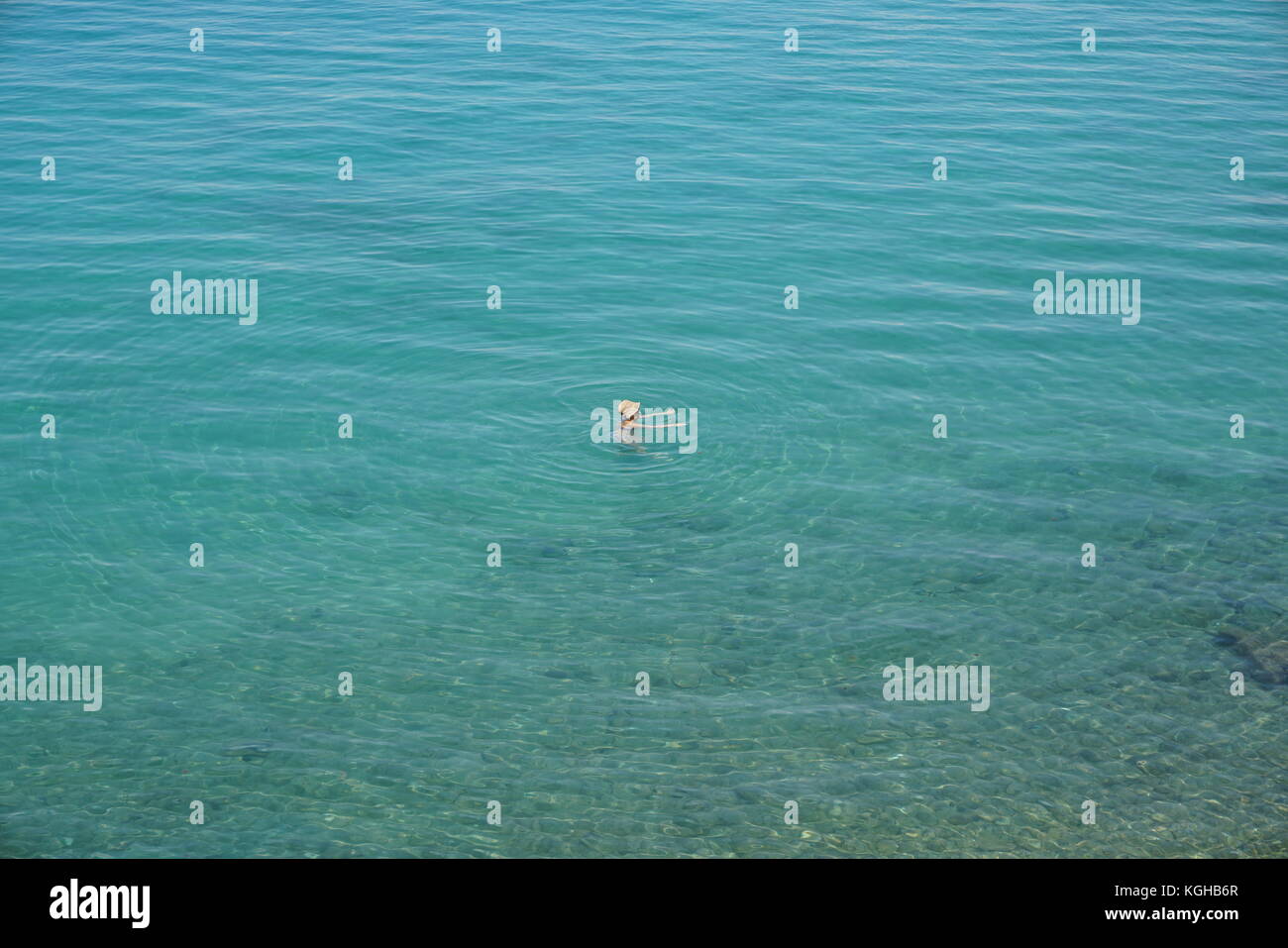 Corfu, Greece: Woman swimming in the sea at the beach of Kerkyra Old ...