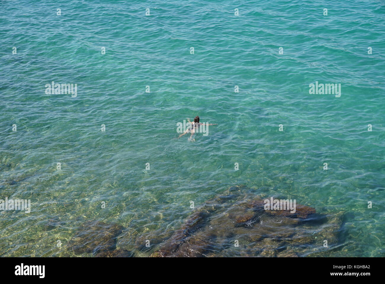 Corfu, Greece: Woman swimming in the sea at the beach of Kerkyra Old ...