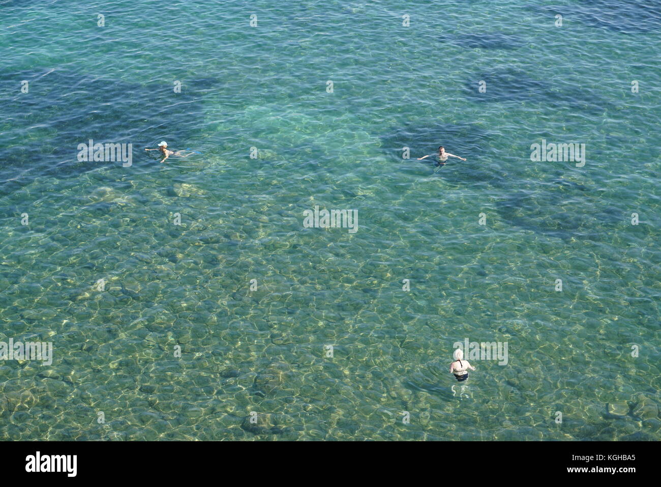 Corfu, Greece: People swimming in the sea at the beach of Kerkyra Old ...