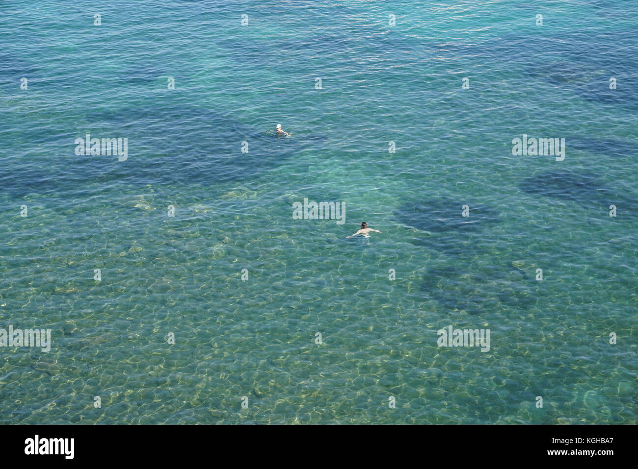 Corfu, Greece: People swimming in the sea at the beach of Kerkyra Old ...