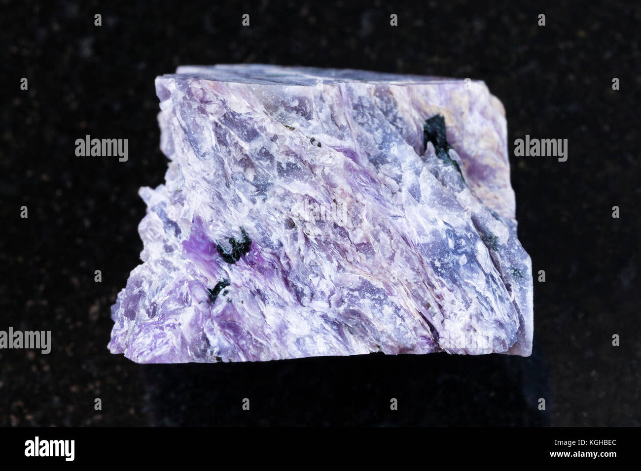 macro shooting of natural mineral rock specimen - raw charoite stone on ...