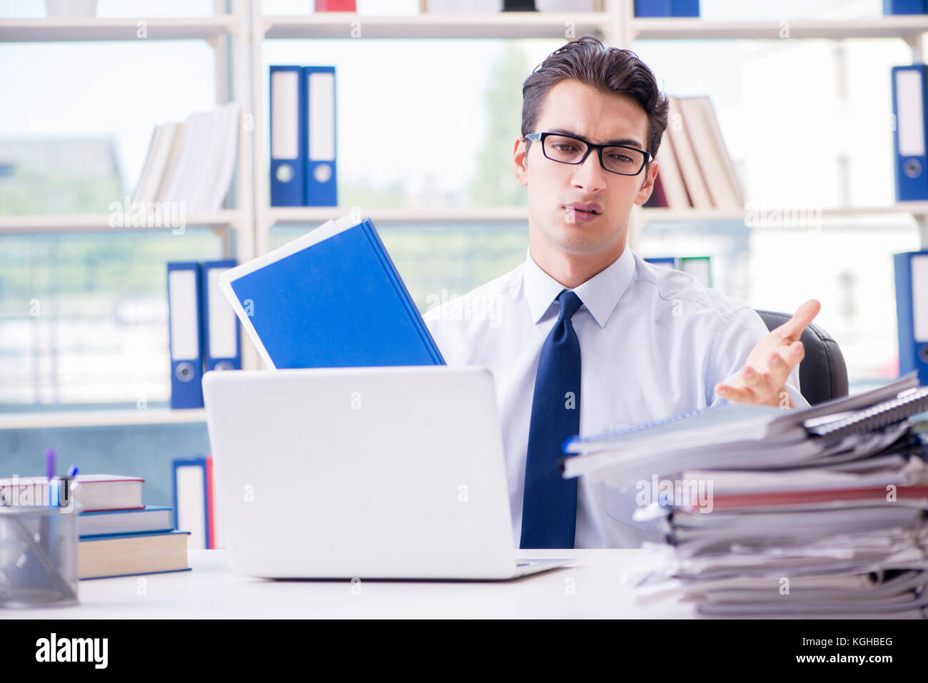 Businessman with excessive work paperwork working in office Stock Photo ...