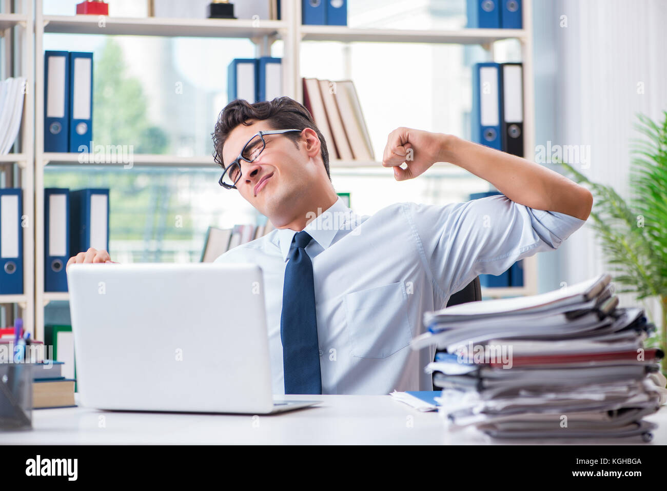 Tired exhausted businessman sitting in the office Stock Photo - Alamy