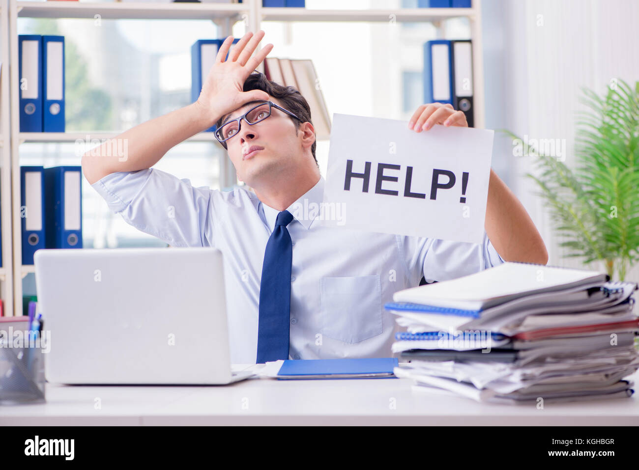 Young businessman asking for help in office Stock Photo - Alamy