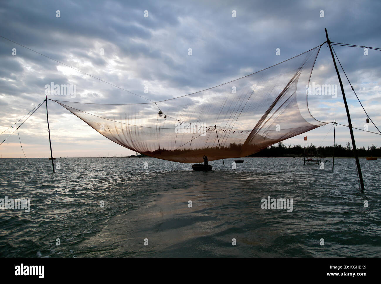 Suspended fishing net in the sea, at the entrance to Thu Bon River, Hoi ...