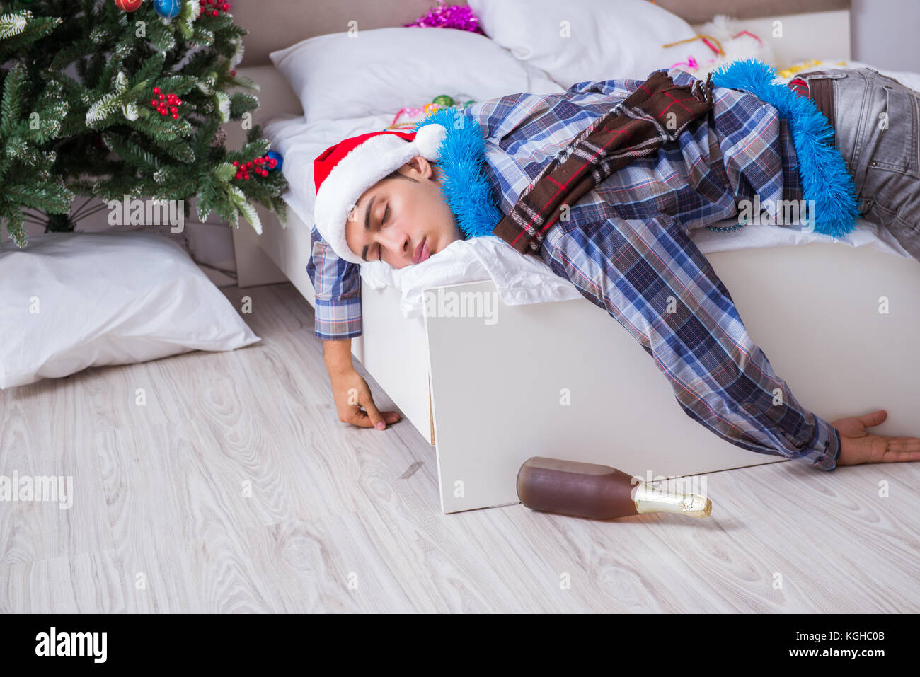 Man suffering hangover after christmas party Stock Photo - Alamy