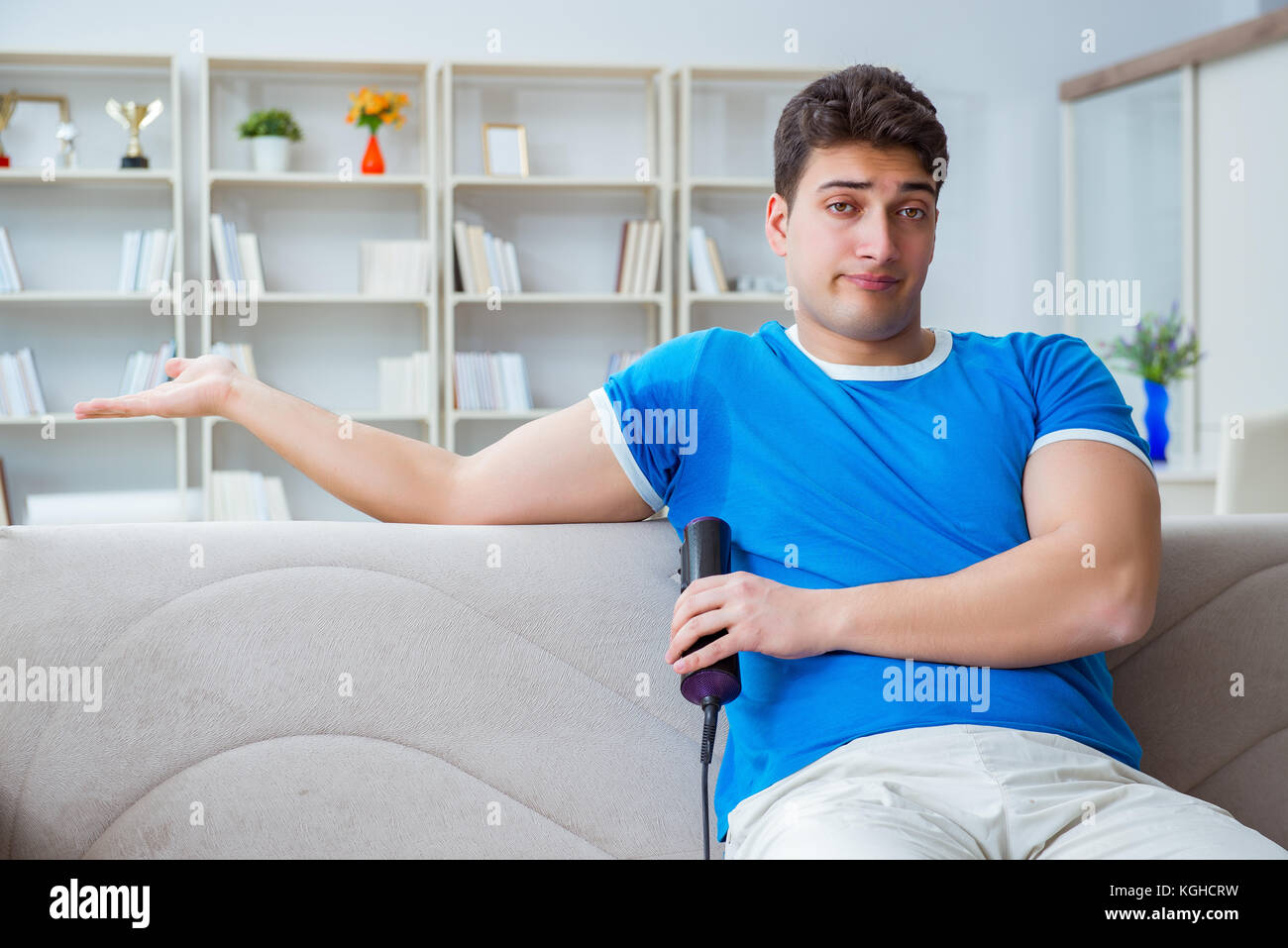 Man sweating excessively smelling bad at home Stock Photo - Alamy