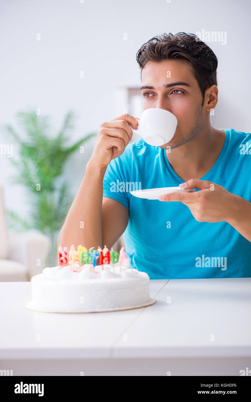 Young man celebrating birthday alone at home Stock Photo - Alamy