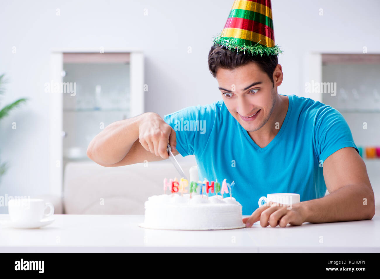 Young man celebrating birthday alone at home Stock Photo - Alamy
