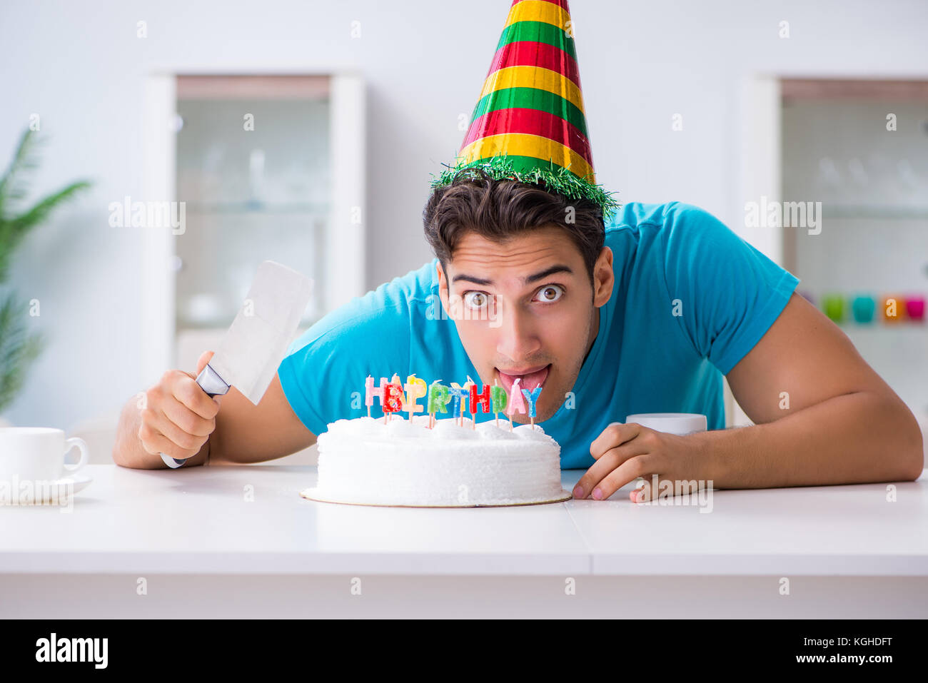 Young man celebrating birthday alone at home Stock Photo - Alamy