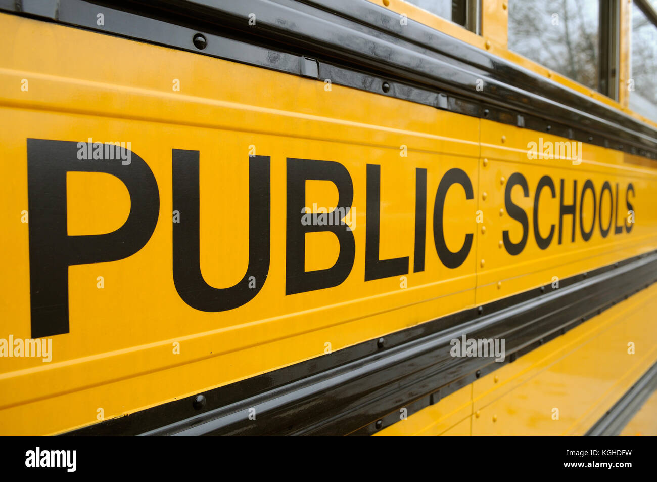 Yellow school bus background. Detail of bus side panel with "Public ...