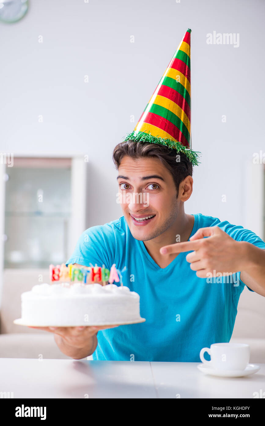 Young man celebrating birthday alone at home Stock Photo - Alamy
