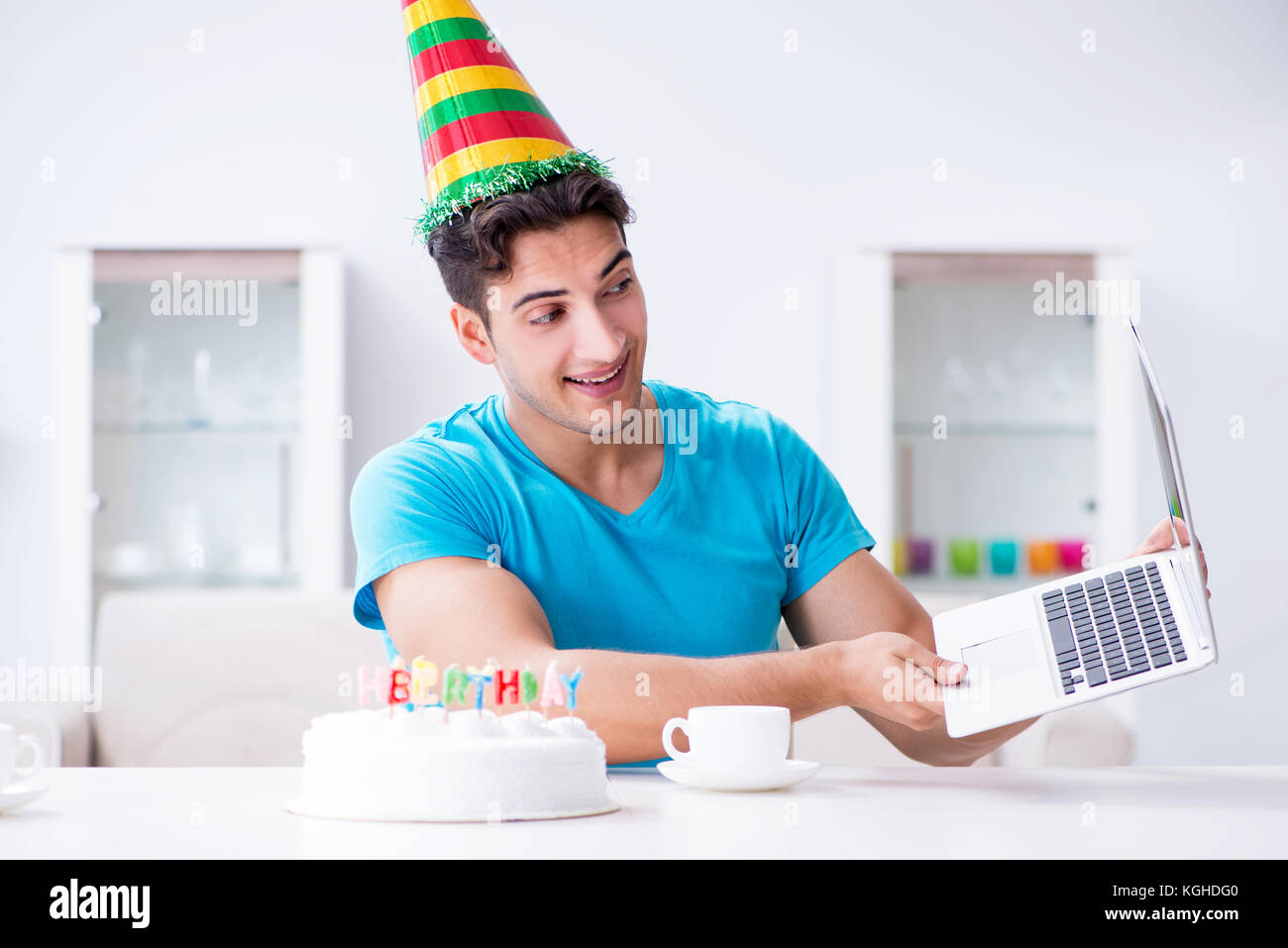 Young man celebrating birthday alone at home Stock Photo - Alamy