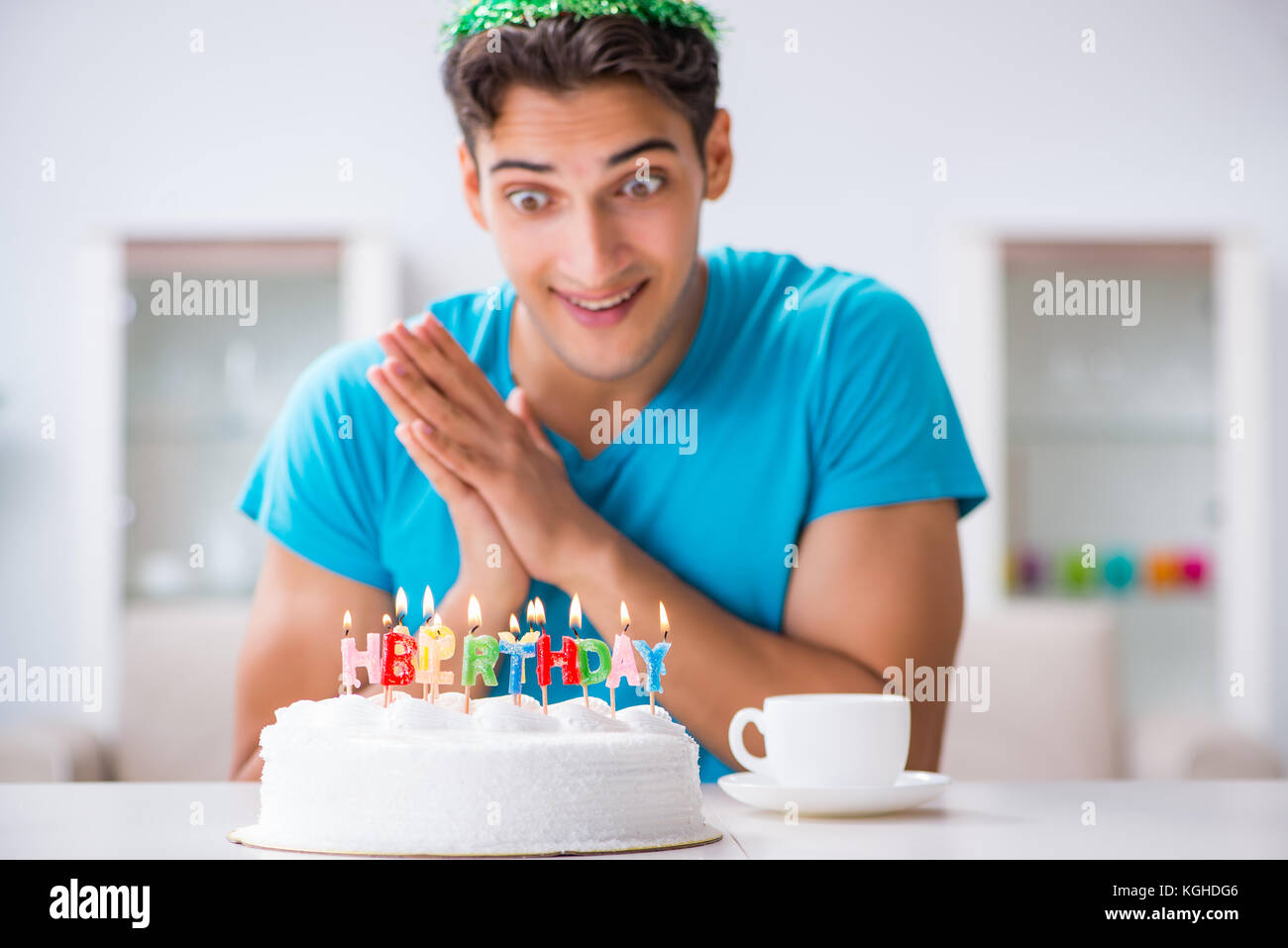 Young man celebrating birthday alone at home Stock Photo - Alamy