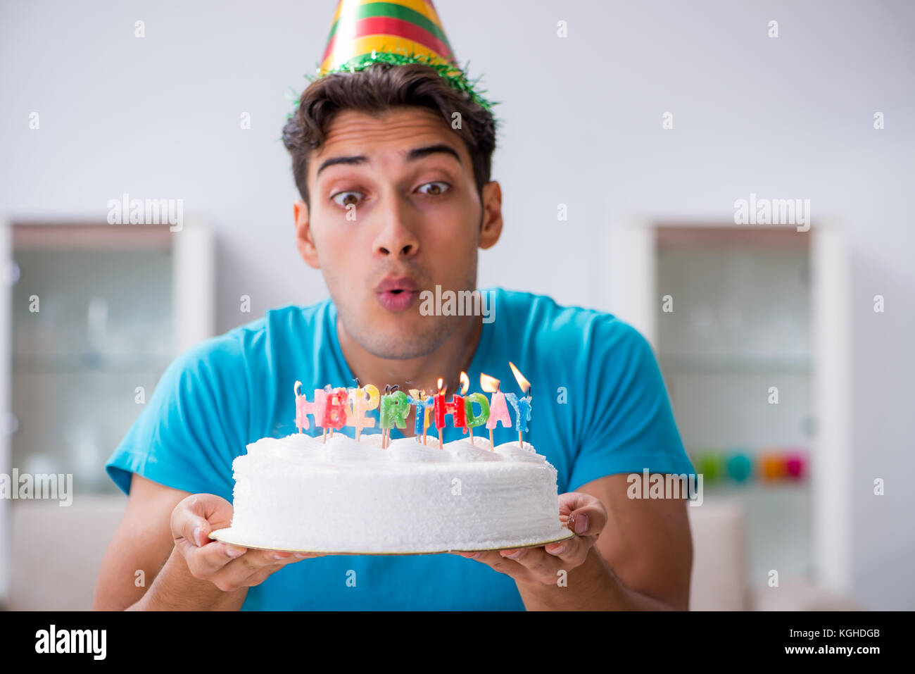 Young man celebrating birthday alone at home Stock Photo - Alamy