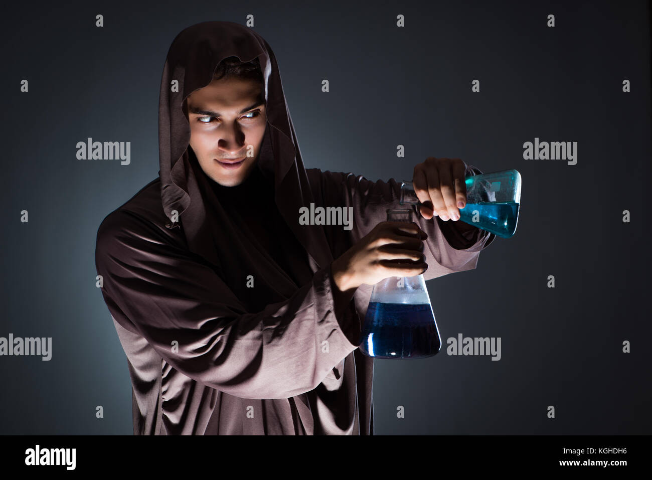 Alchemist doing experiments in alchemy concept Stock Photo - Alamy