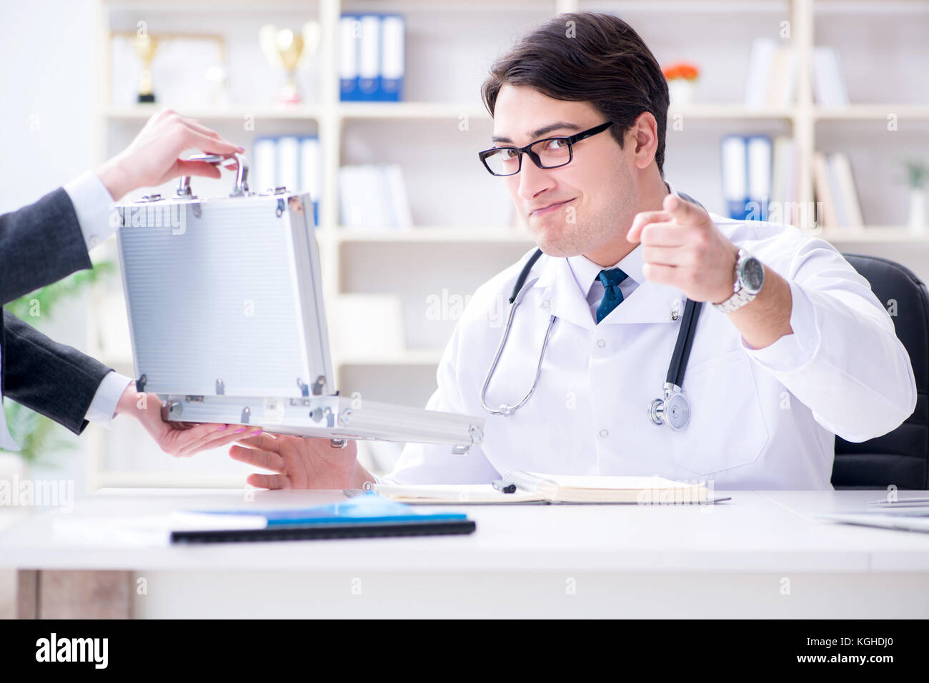 Young doctor in medical insurance fraud concept Stock Photo - Alamy