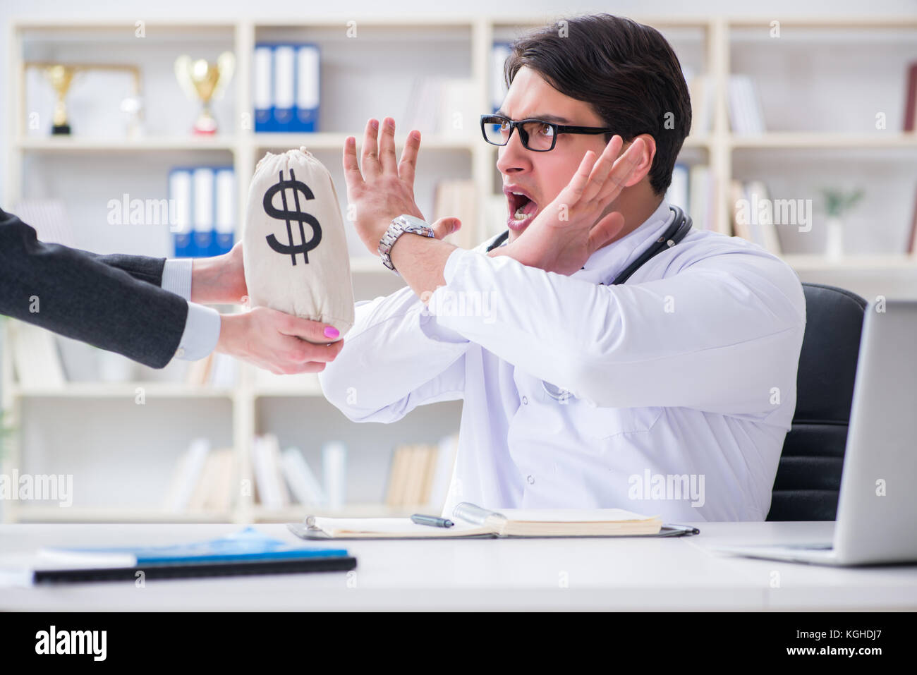 Young doctor in medical insurance fraud concept Stock Photo - Alamy