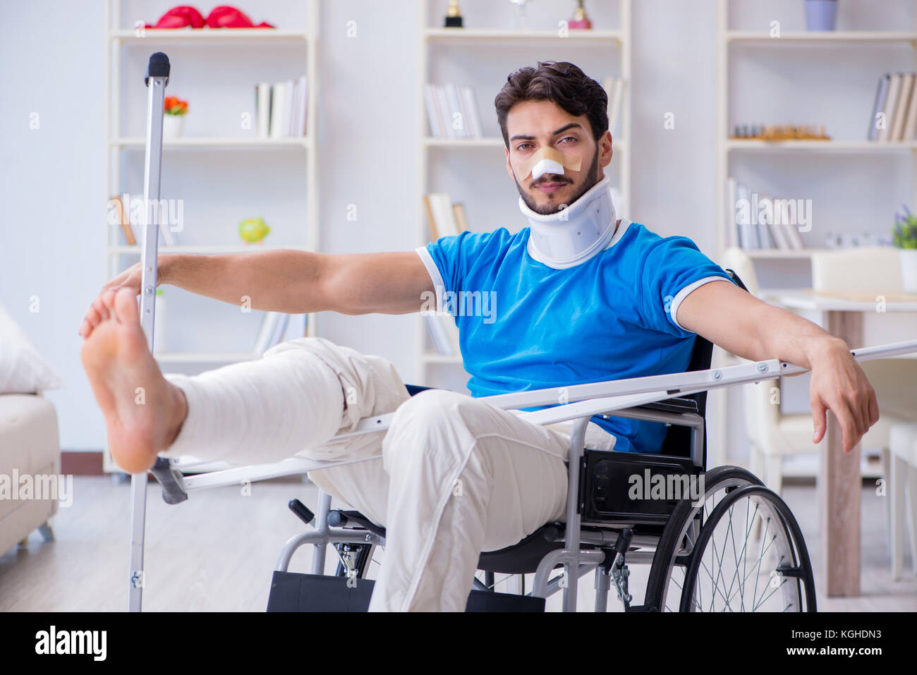 Injured young man recovering at home Stock Photo - Alamy