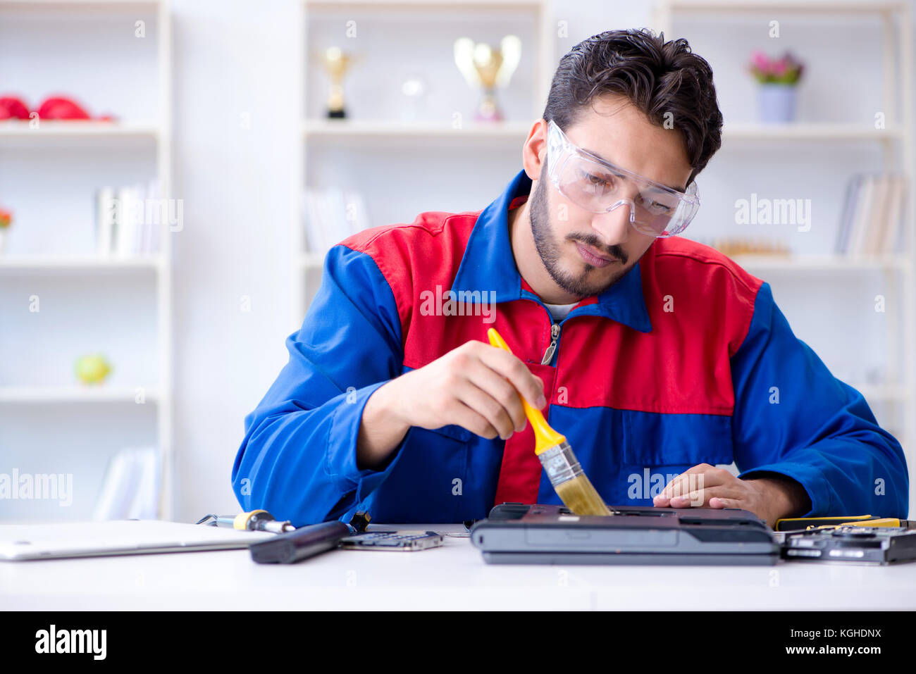 Repairman working in technical support fixing computer laptop ...