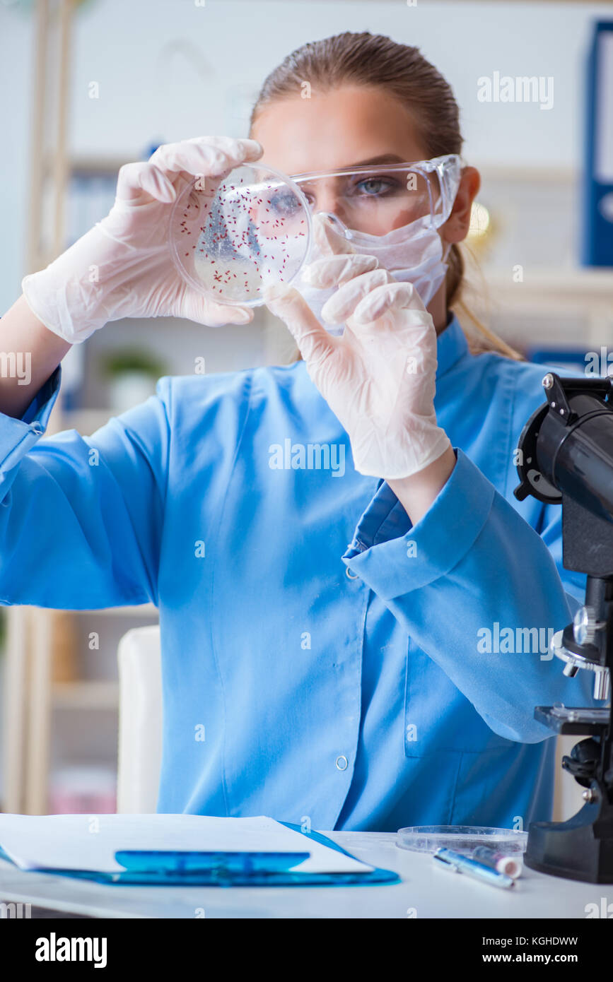 Female scientist researcher conducting an experiment in a laboratory ...