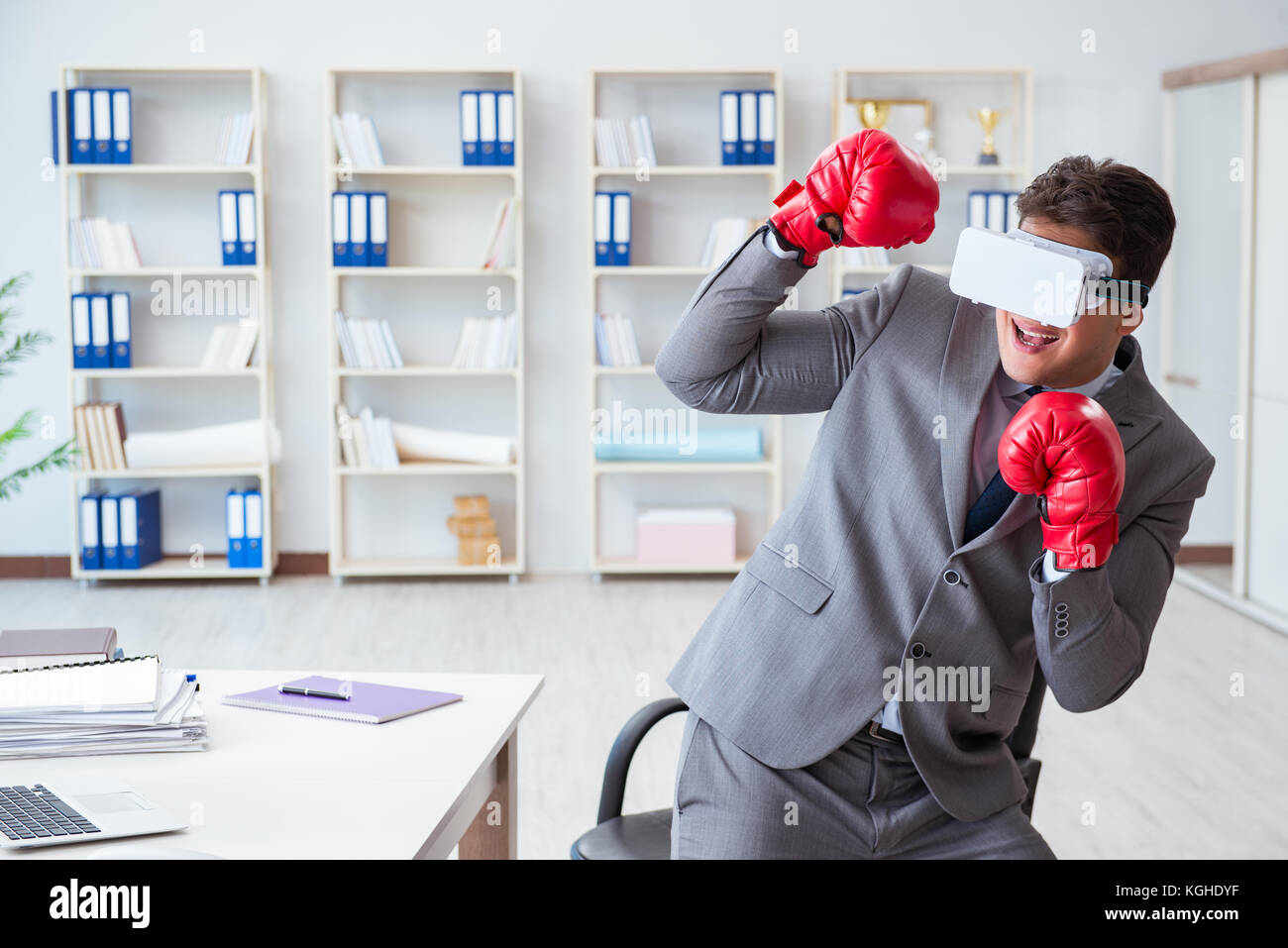 Man boxing in the office with virtual reality goggles Stock Photo - Alamy