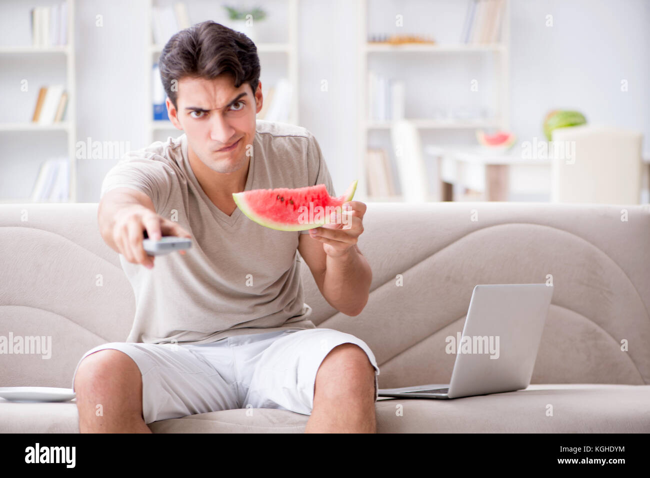 Man eating watermelon at home Stock Photo - Alamy