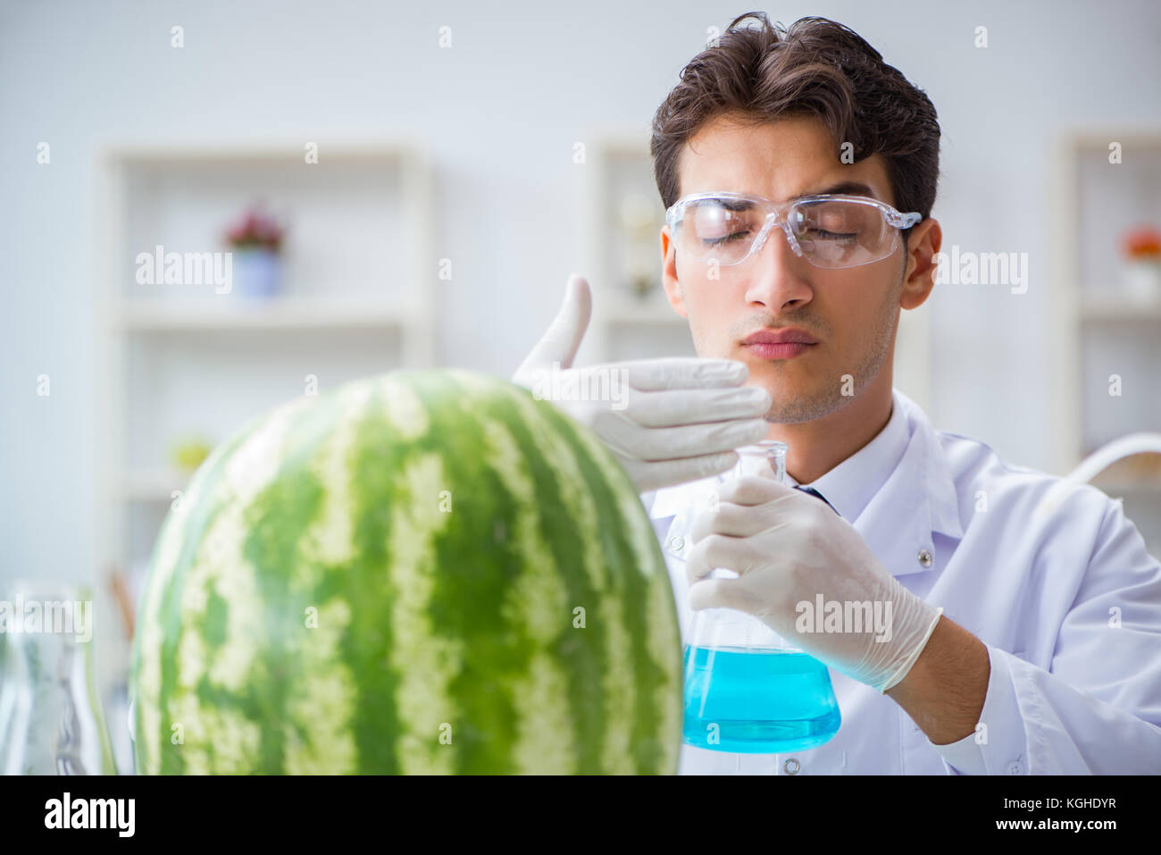 Scientist testing watermelon in lab Stock Photo - Alamy