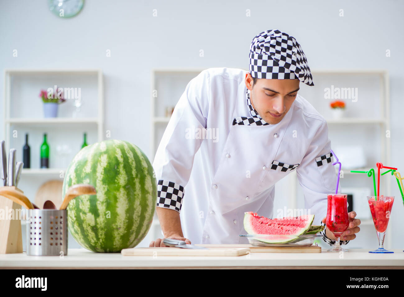 Male cook with watermelon in kitchen Stock Photo - Alamy
