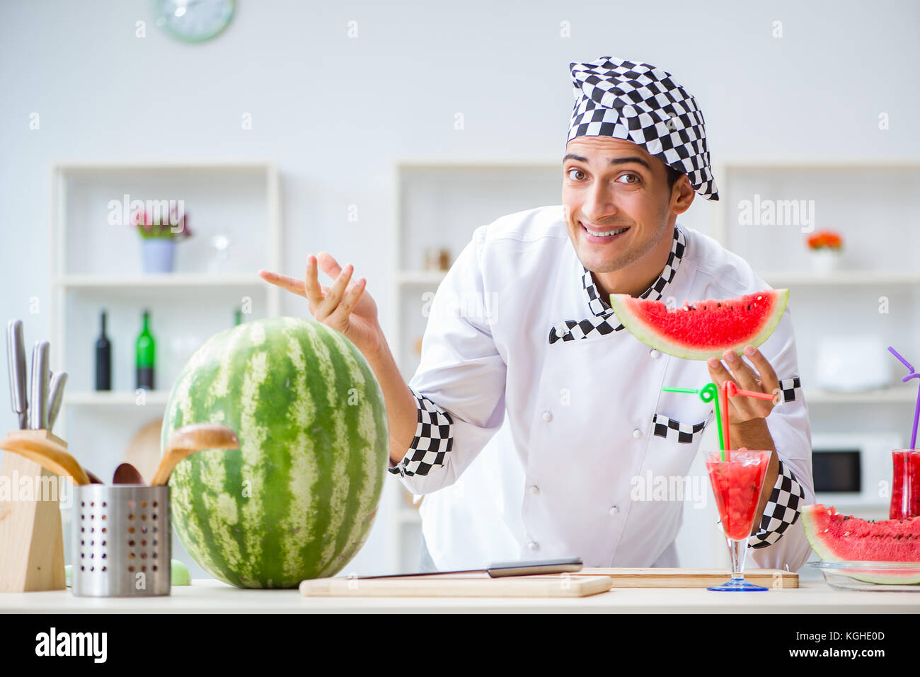 Male cook with watermelon in kitchen Stock Photo - Alamy