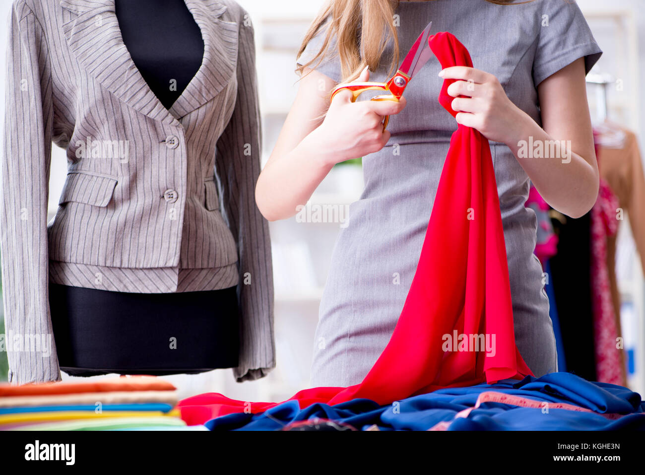 Young woman tailor working in workshop on new dress Stock Photo - Alamy
