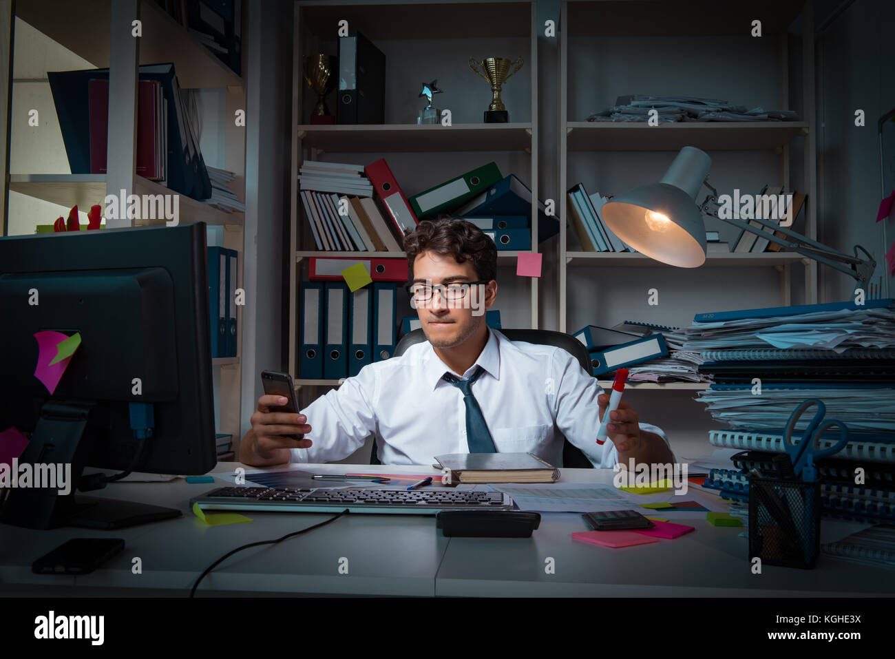 Man businessman working late hours in the office Stock Photo - Alamy
