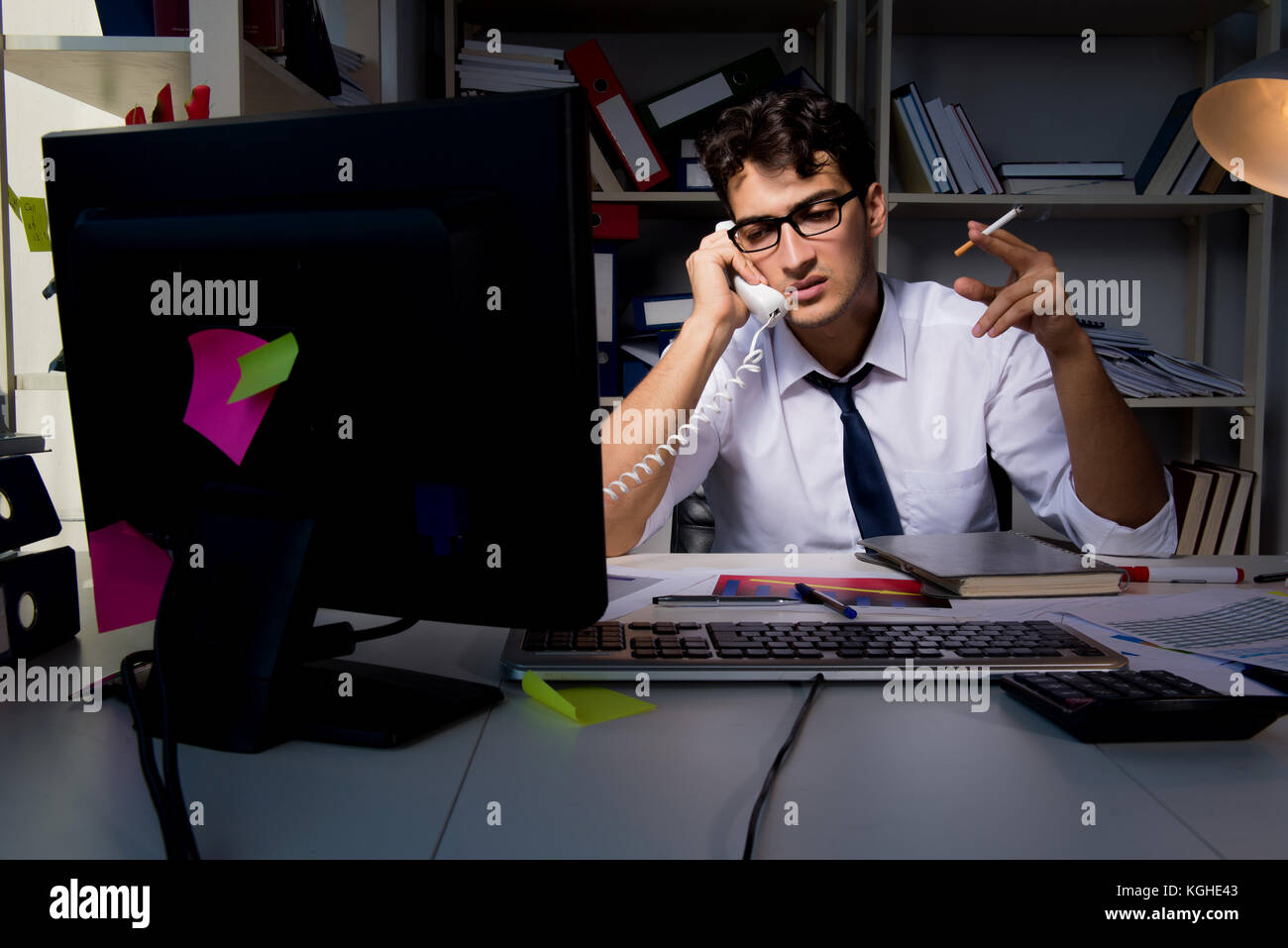 Man businessman working late hours in the office Stock Photo - Alamy