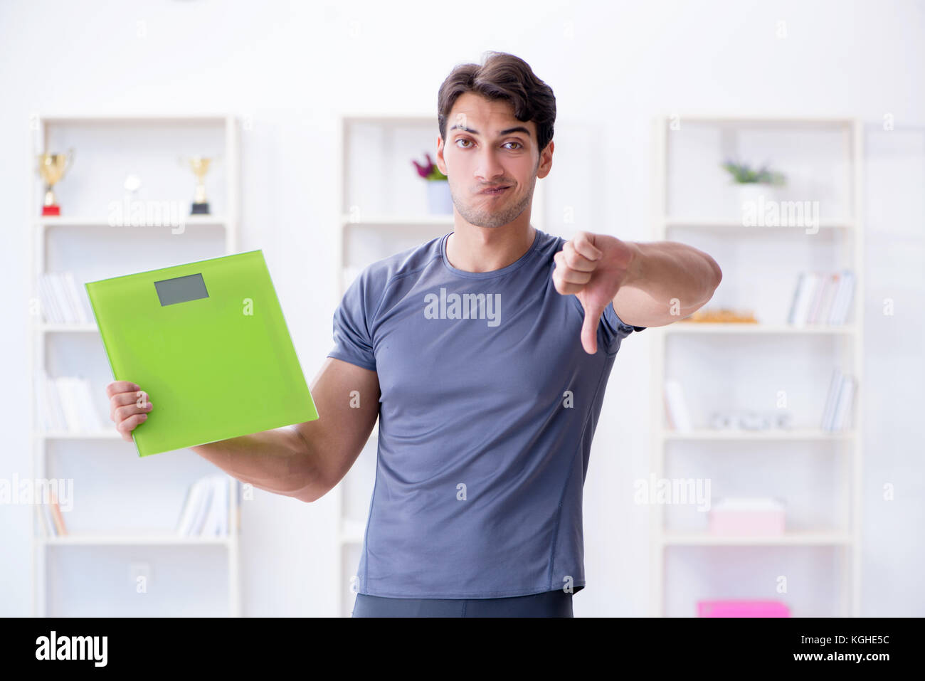 Man with scales in sports and health concept Stock Photo - Alamy