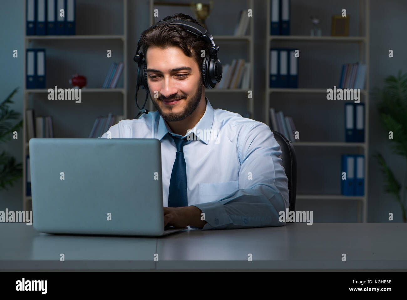 Young man in call center concept working late overtime in office Stock ...