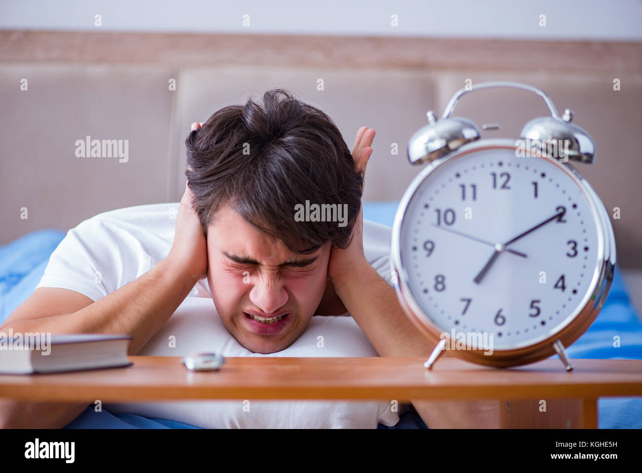 Man in bed frustrated suffering from insomnia with an alarm clock Stock ...