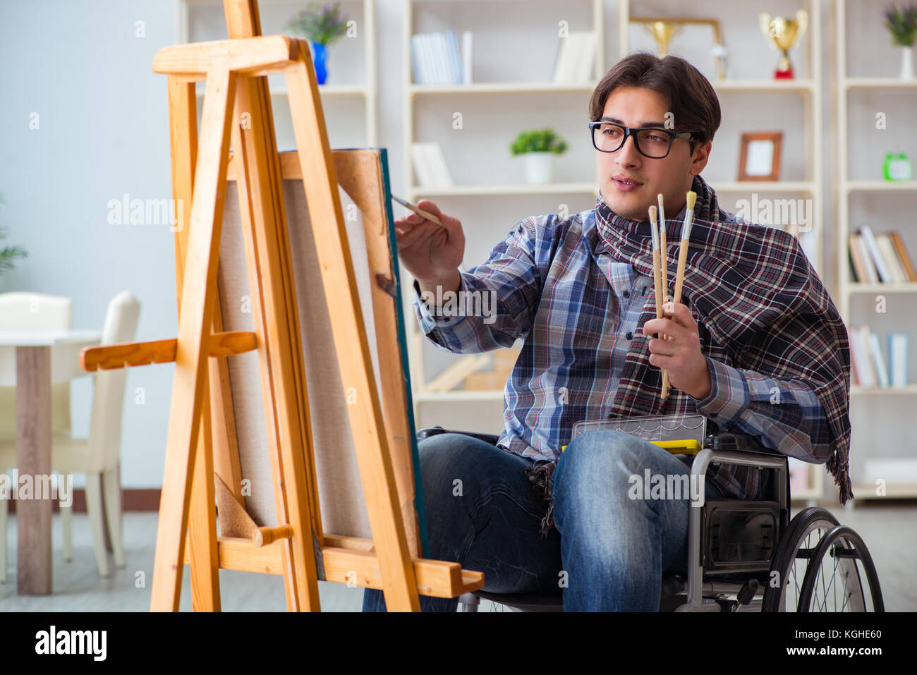 Disabled artist painting picture in studio Stock Photo - Alamy