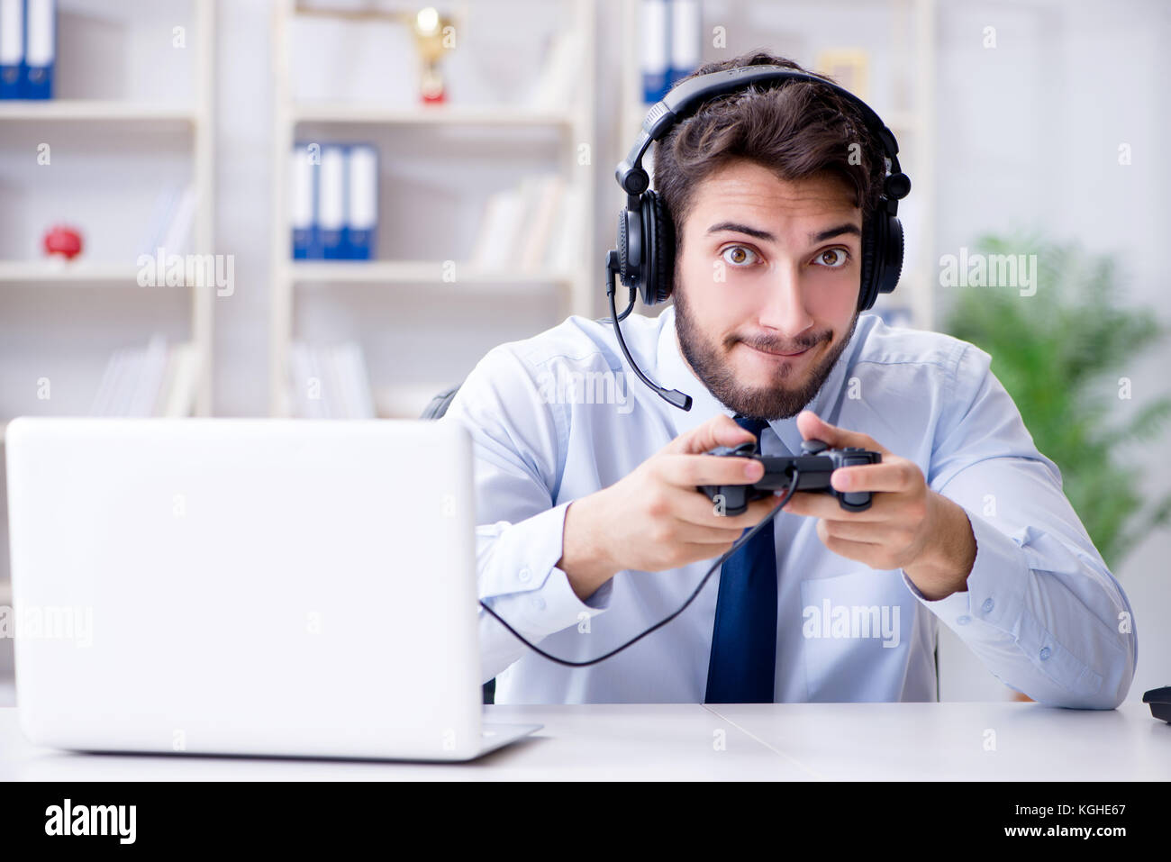Businessman gamer in office playing games Stock Photo - Alamy