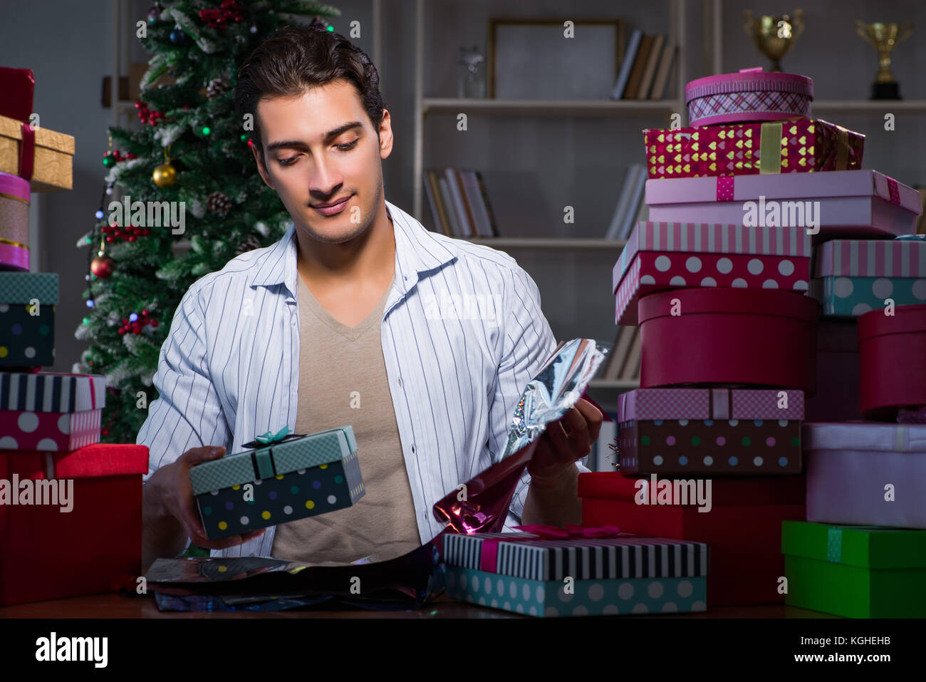 Man with many christmas gifts in boxes Stock Photo - Alamy