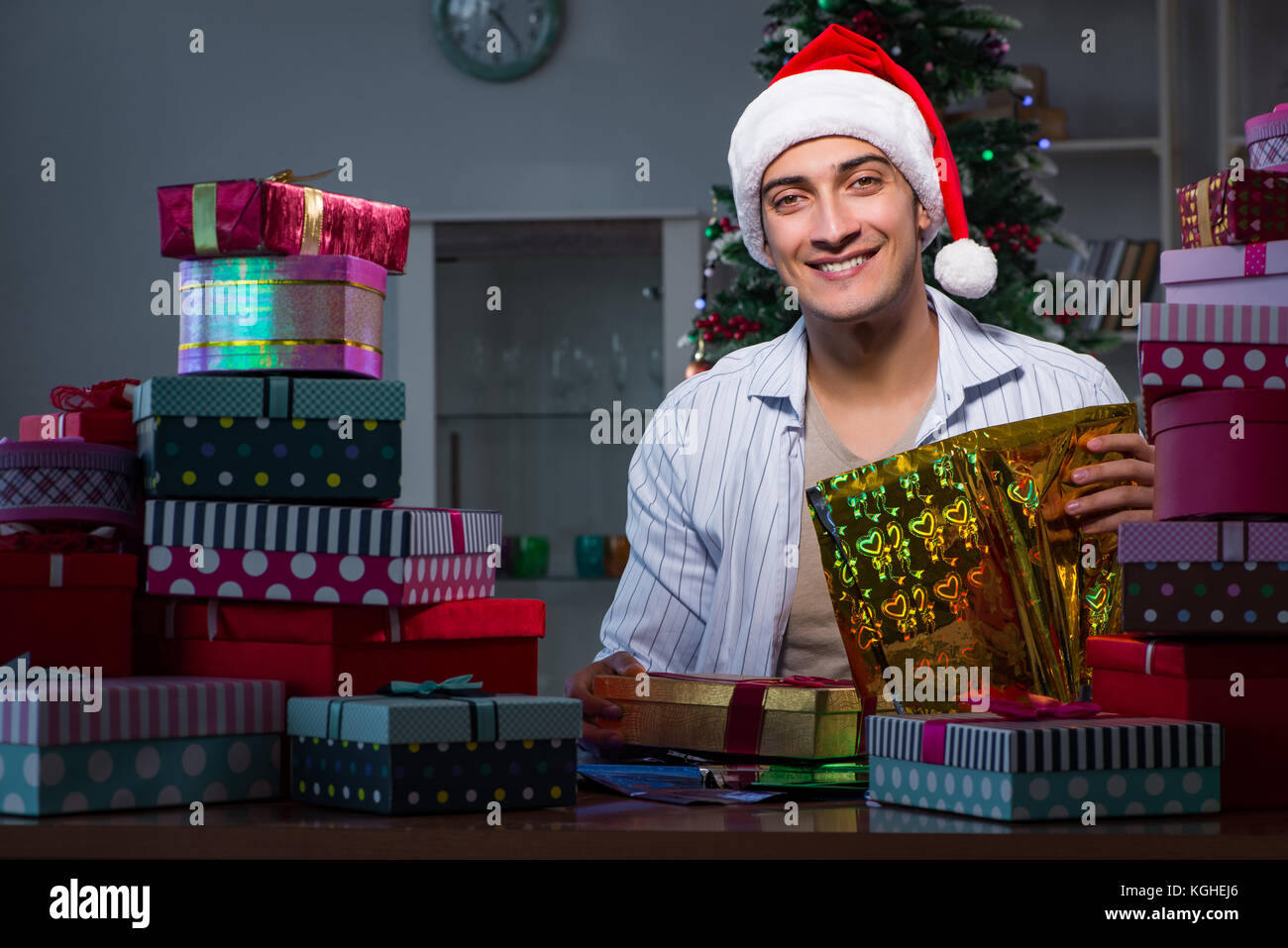 Man with many christmas gifts in boxes Stock Photo - Alamy