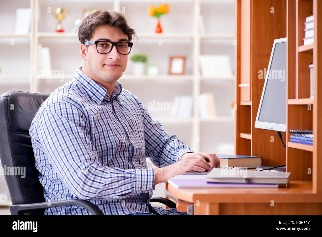 Young student at computer table Stock Photo - Alamy