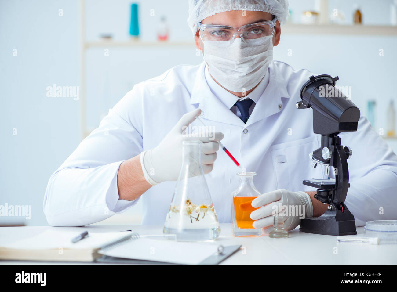 Chemist mixing perfumes in the lab Stock Photo - Alamy