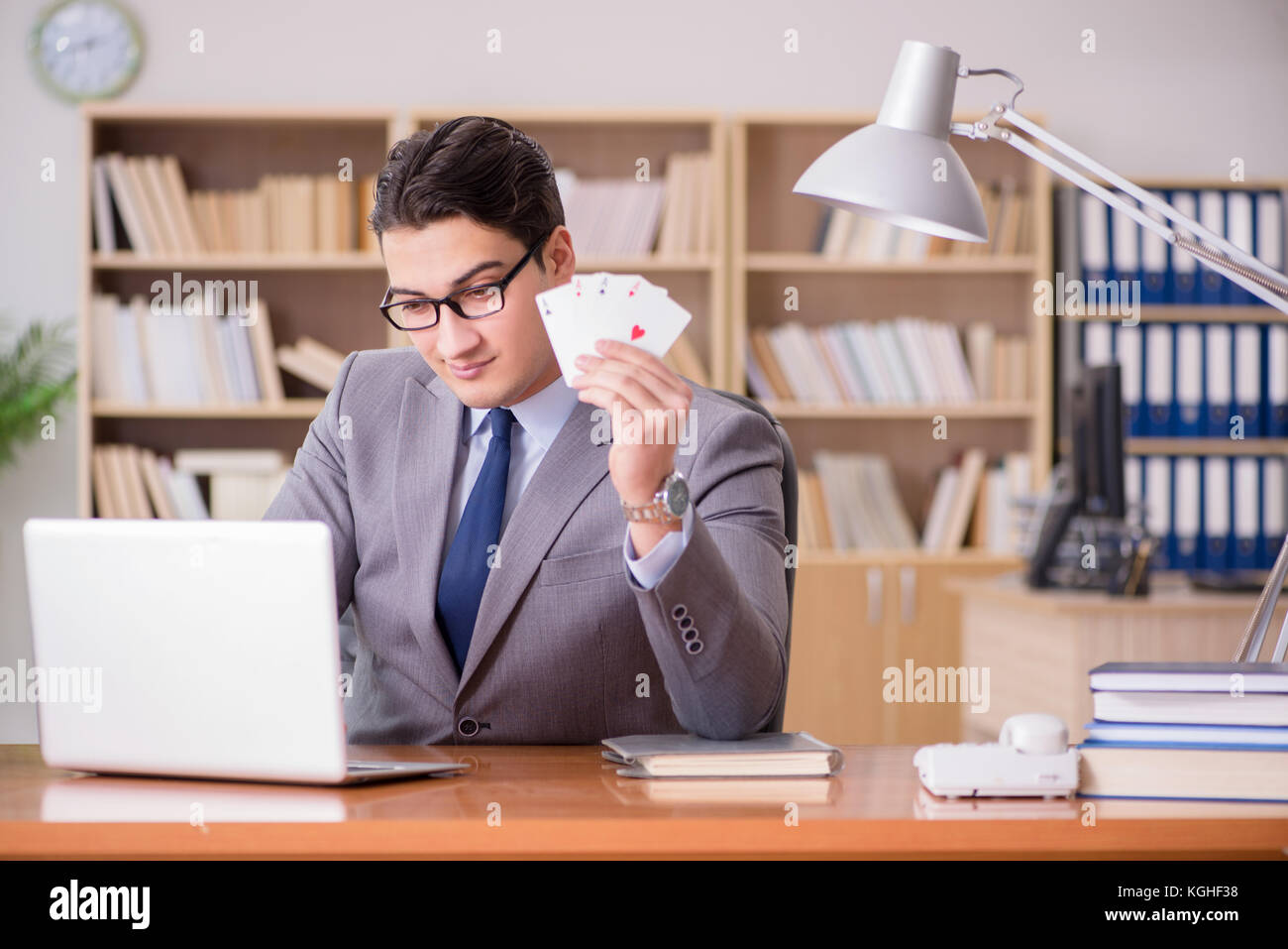 Businessman gambling playing cards at work Stock Photo - Alamy