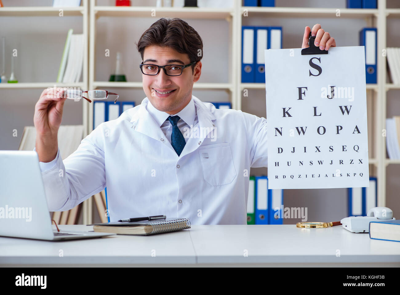 Doctor optician with letter chart conducting an eye test check Stock ...