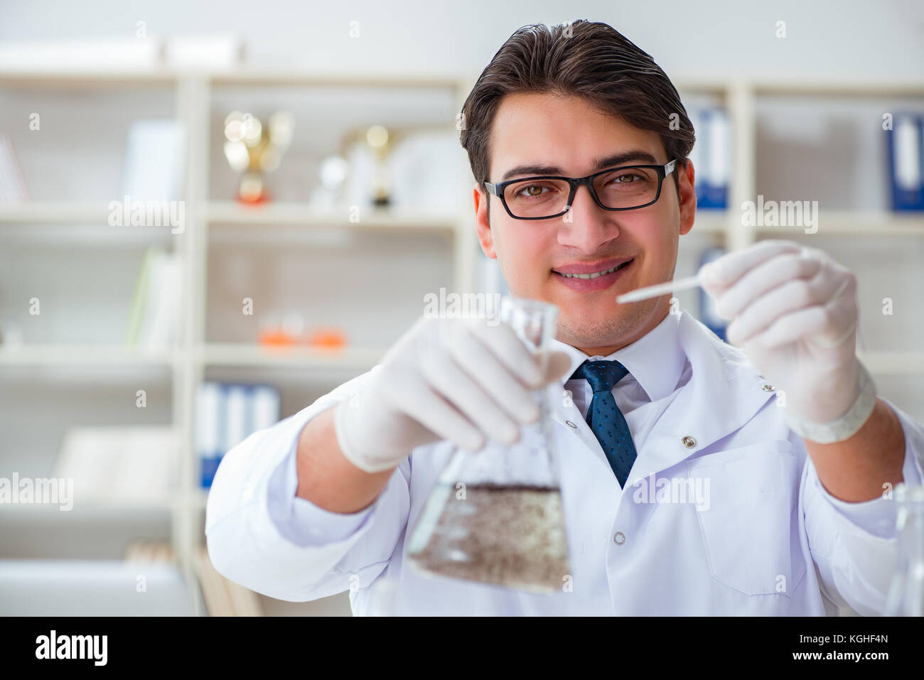 Young researcher scientist doing a water test contamination experiment ...