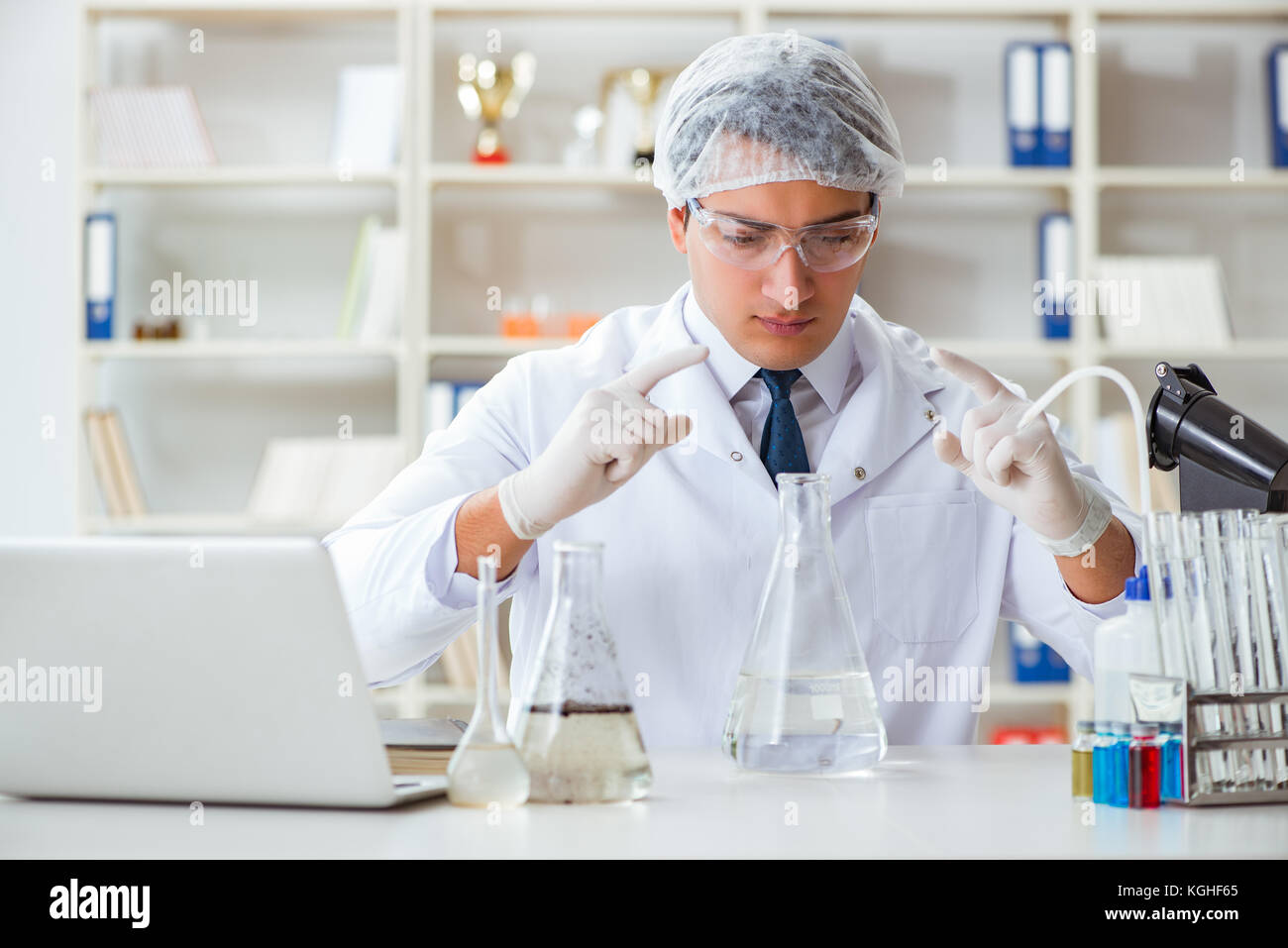 Young researcher scientist doing a water test contamination experiment ...