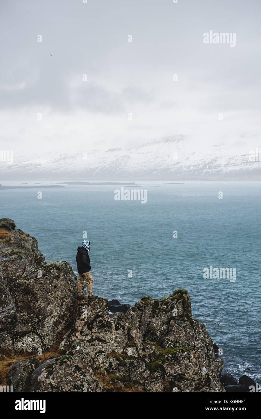 a Man standing on cliff in rainy day, travel lifestyle concept Stock ...