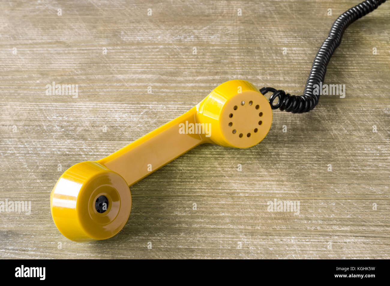 Yellow receiver of old vintage classic telephone Stock Photo - Alamy