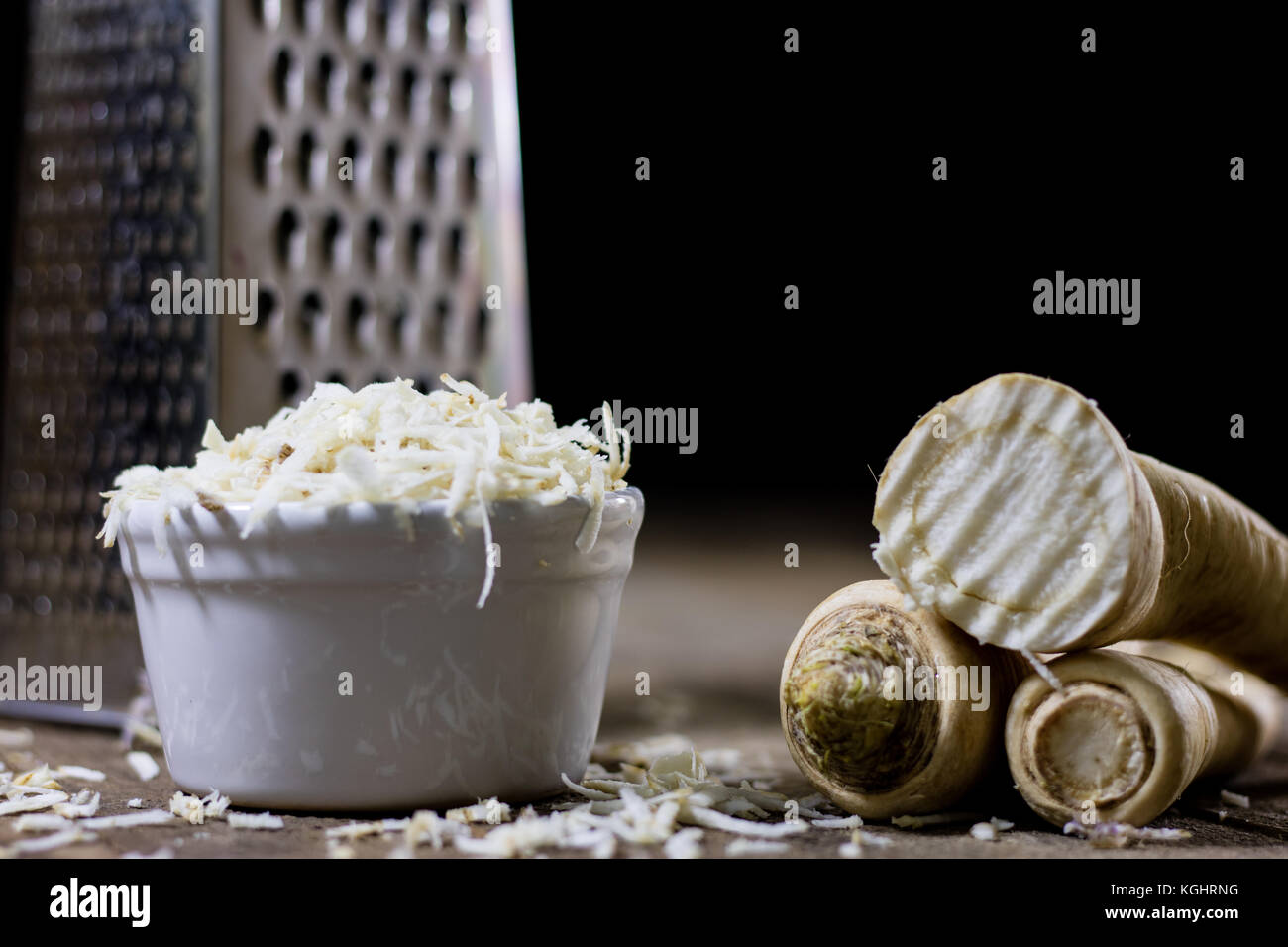Root of parsley root on grater. Grate and parsley on the old kitchen ...